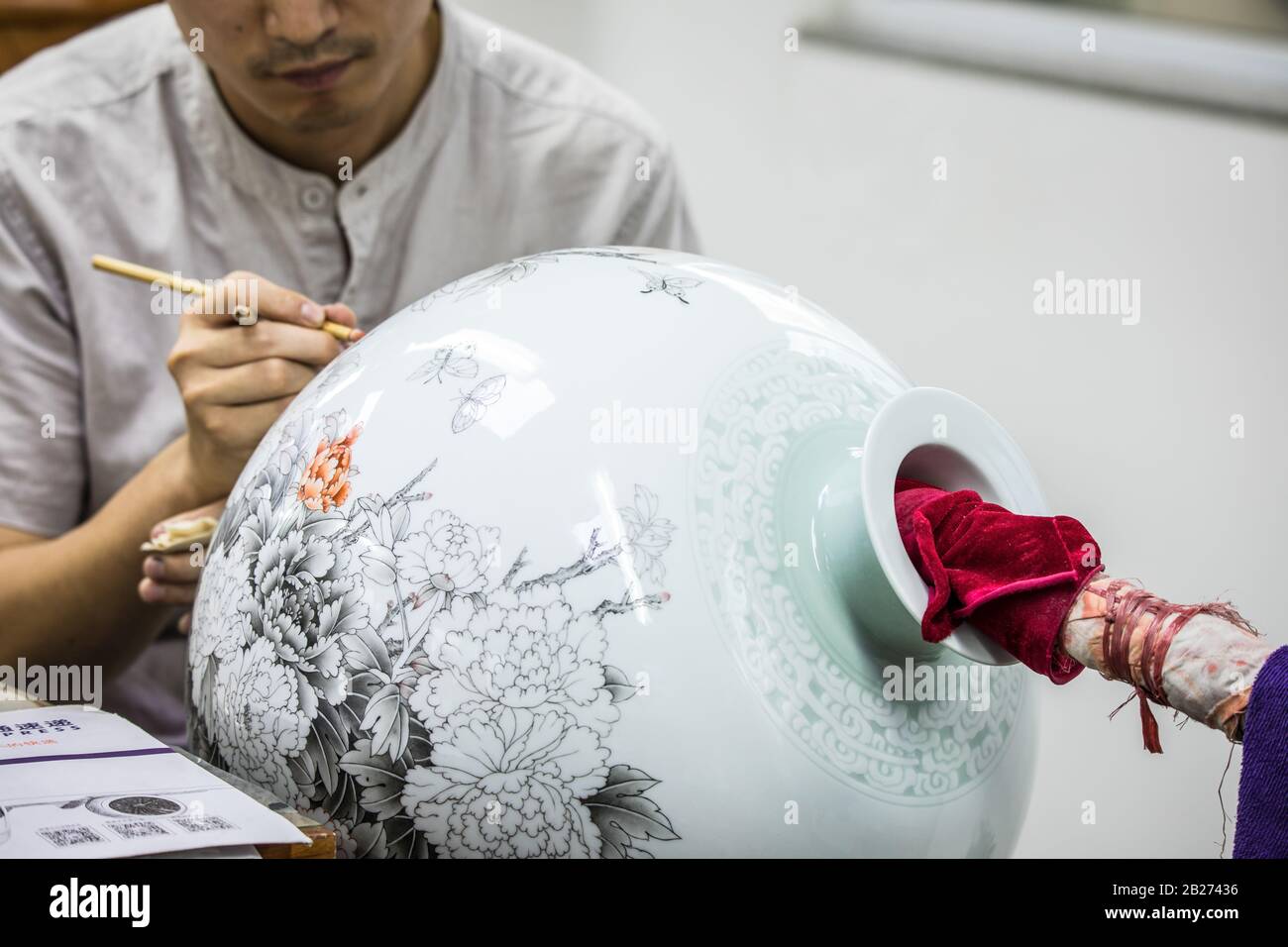 BEIJING, СHINA - JUNE 03: Chinese craftsman paints a large porcelain ...
