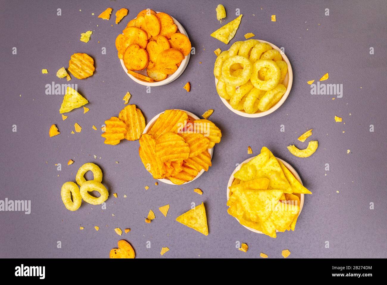 Assorted salty spiced snacks. Chips, rings, nachos, crackers. In ...