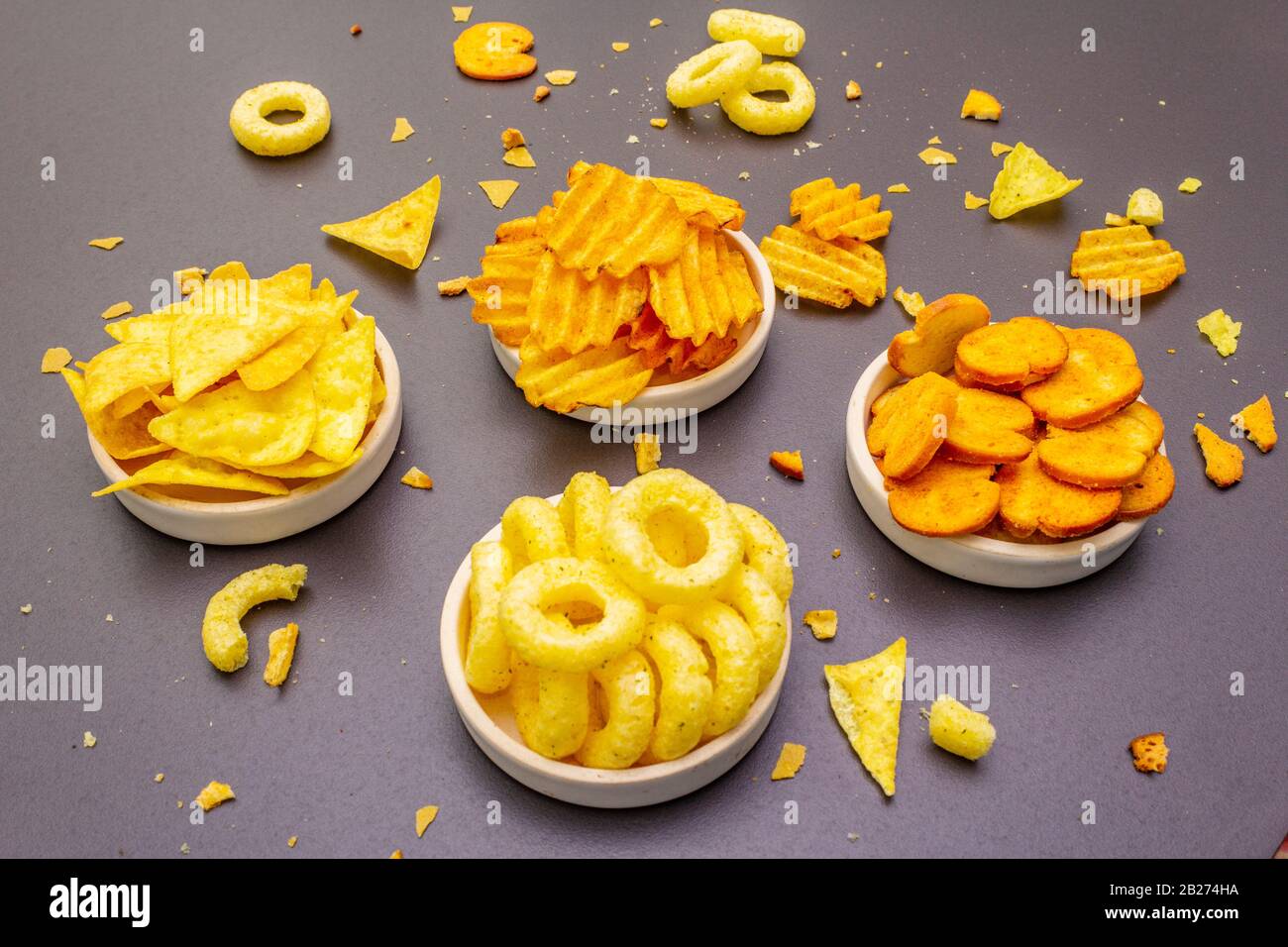 Assorted salty spiced snacks. Chips, rings, nachos, crackers. In ...