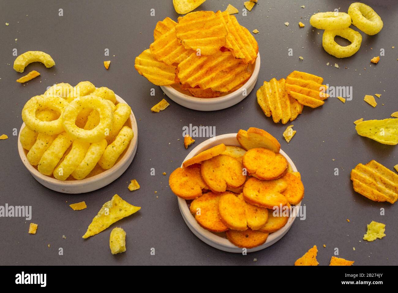 Assorted salty spiced snacks. Chips, rings, nachos, crackers. In ...
