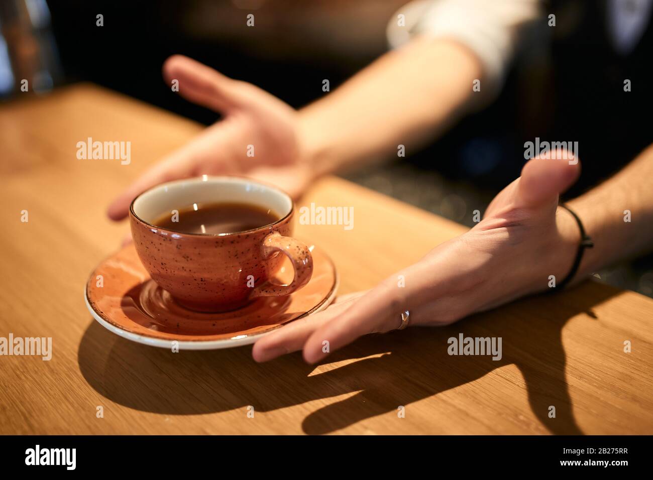 man giving a cup of tasty tea to customer, clients, here is you tea ...