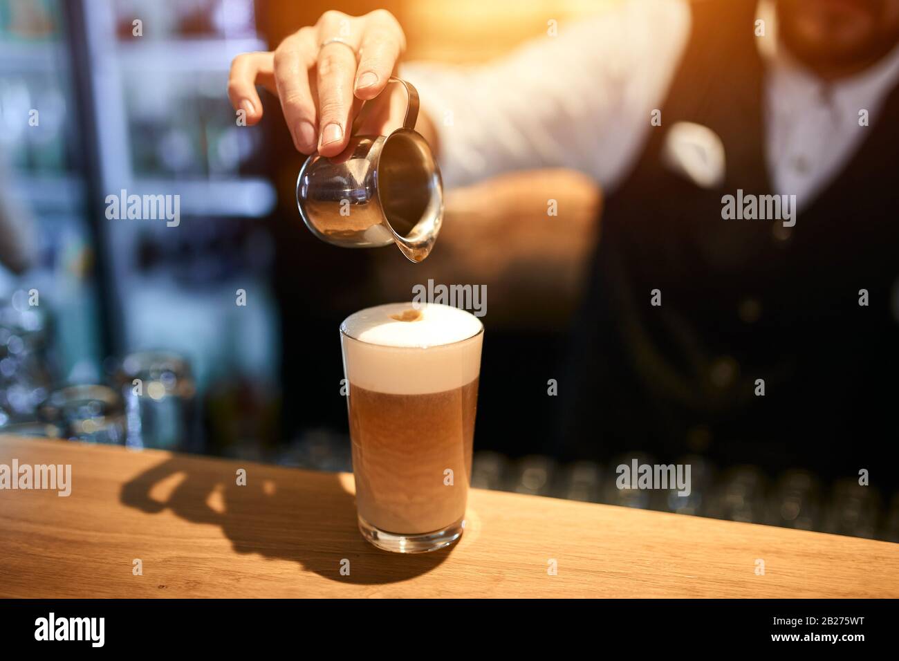 young man's hand pour cocoa, cacao into the glass, close up photo ...