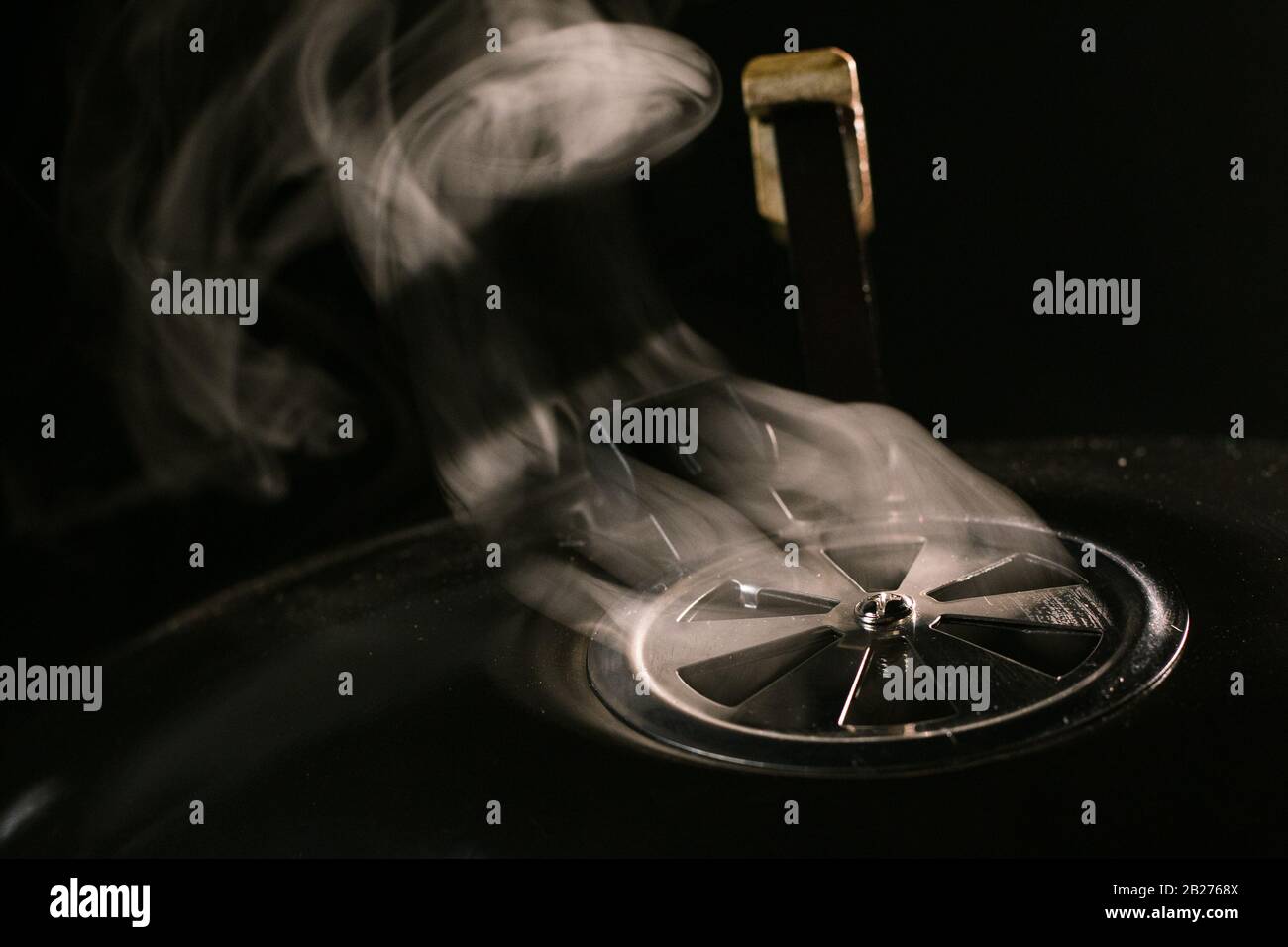 Hot grill for cooking with smoke on a black background side view Stock ...