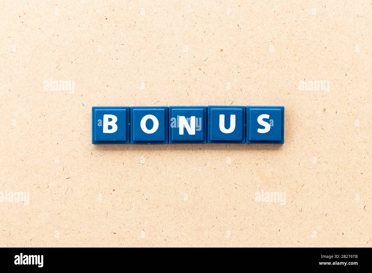 Tile letter in word bonus on wood background Stock Photo - Alamy