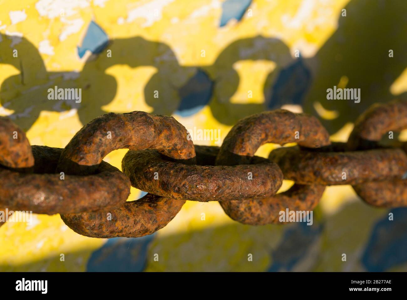 Rusted iron chain casts a shadow on a boat Stock Photo - Alamy