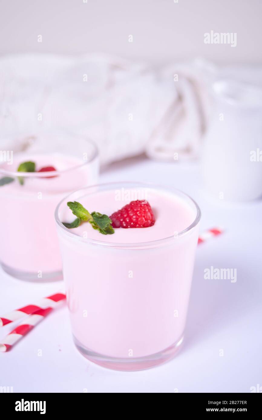 Two portions natural homemade yogurt in a glass jar with fresh ...