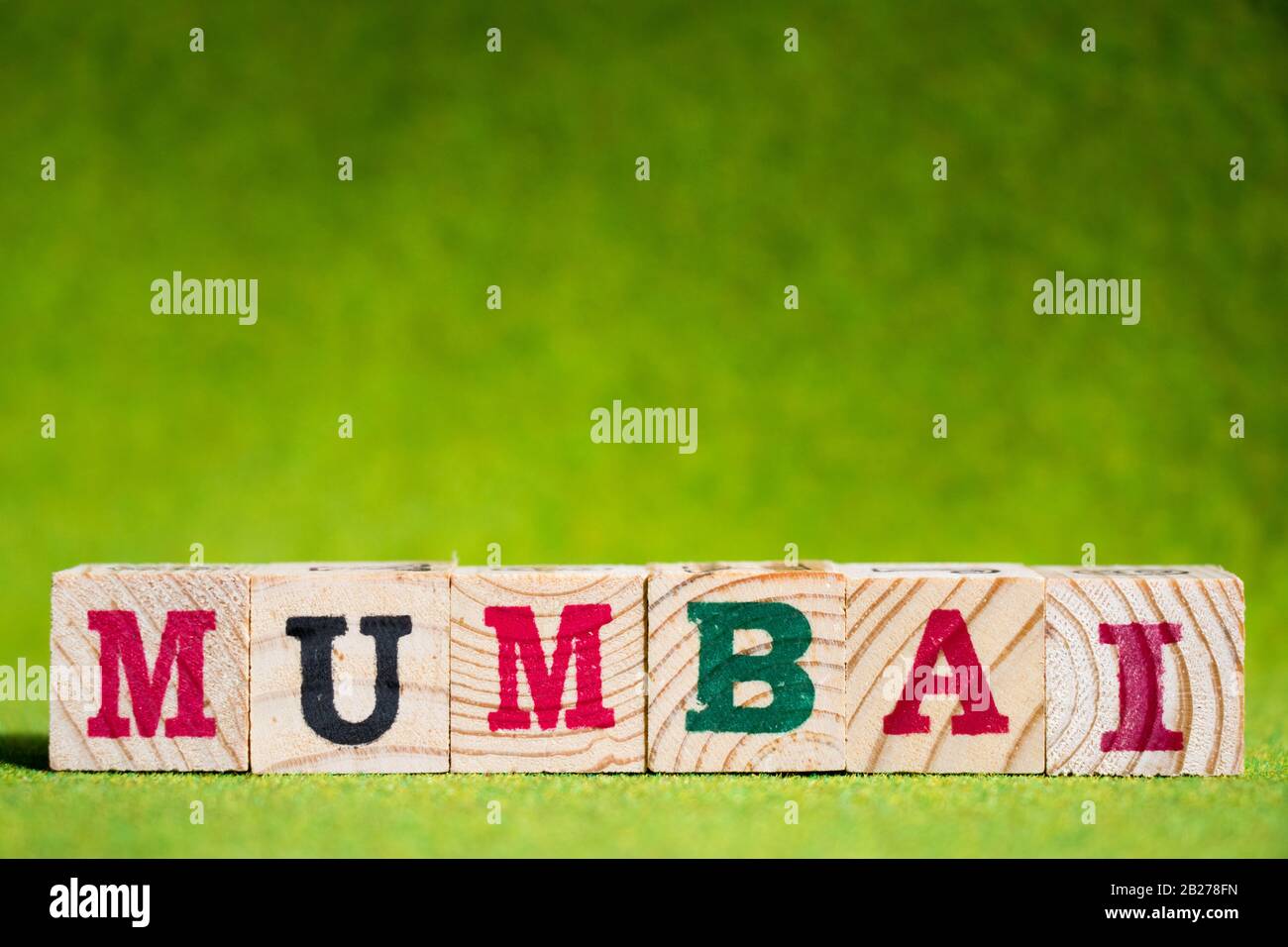 Letter block in word mumbai on artificial green background Stock Photo ...