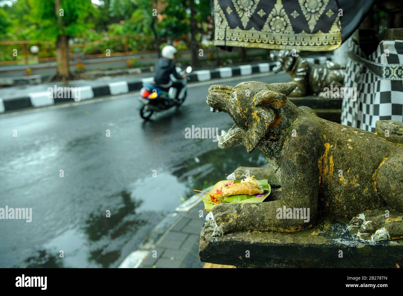Carved Tiger statues, or Dvarapala, guarding a small Hindu shrine at a ...