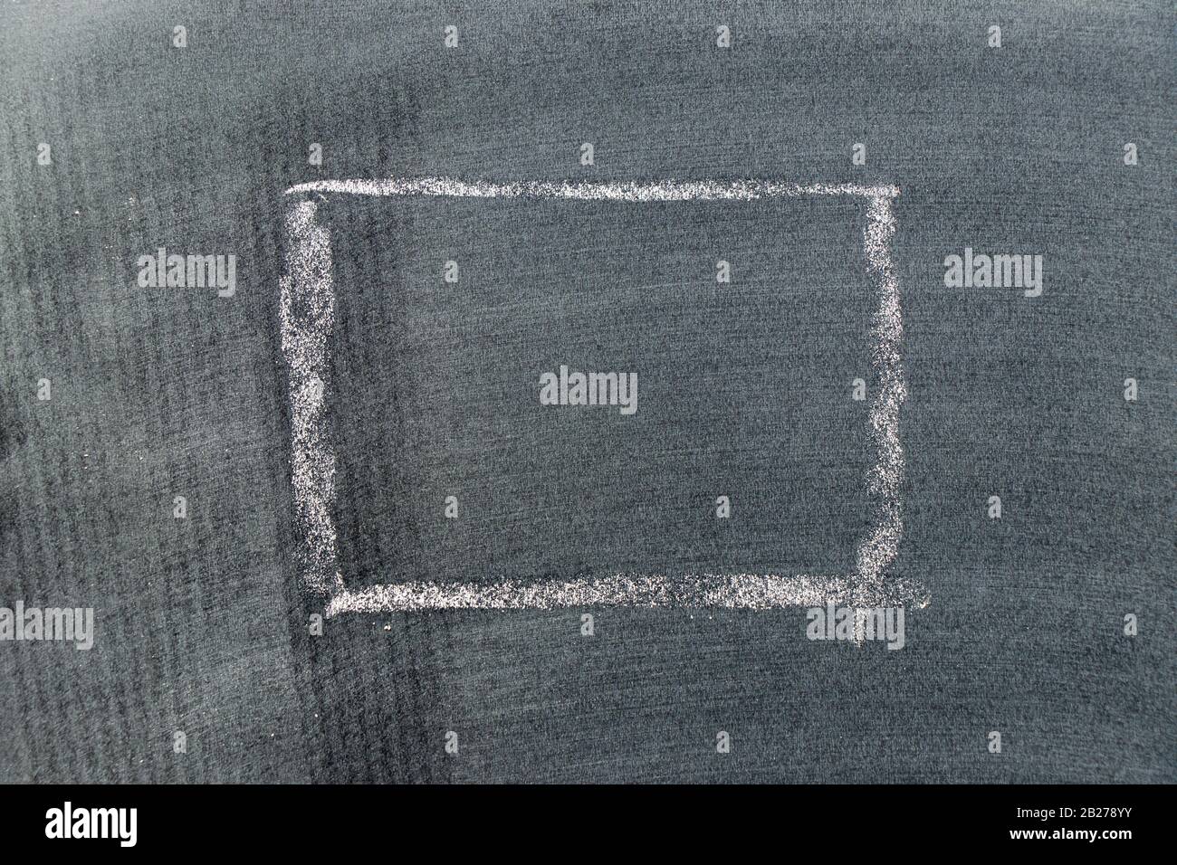 White color chalk hand drawing in square shape on black board ...