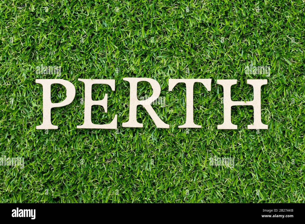 Wood alphabet letter in word Perth on green grass background Stock ...