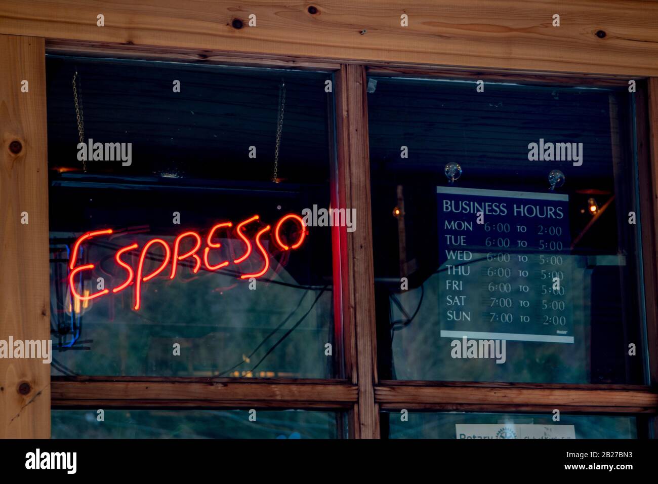 Red Neon Expresso Light from the window with the business hours sign in ...