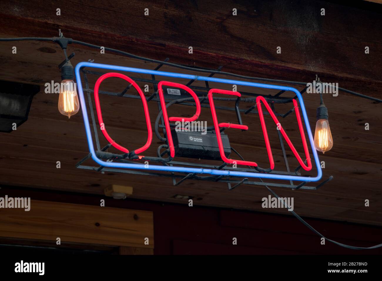 Red and Blue Neon Light Open Sign hanging from a wooded rafter Stock ...