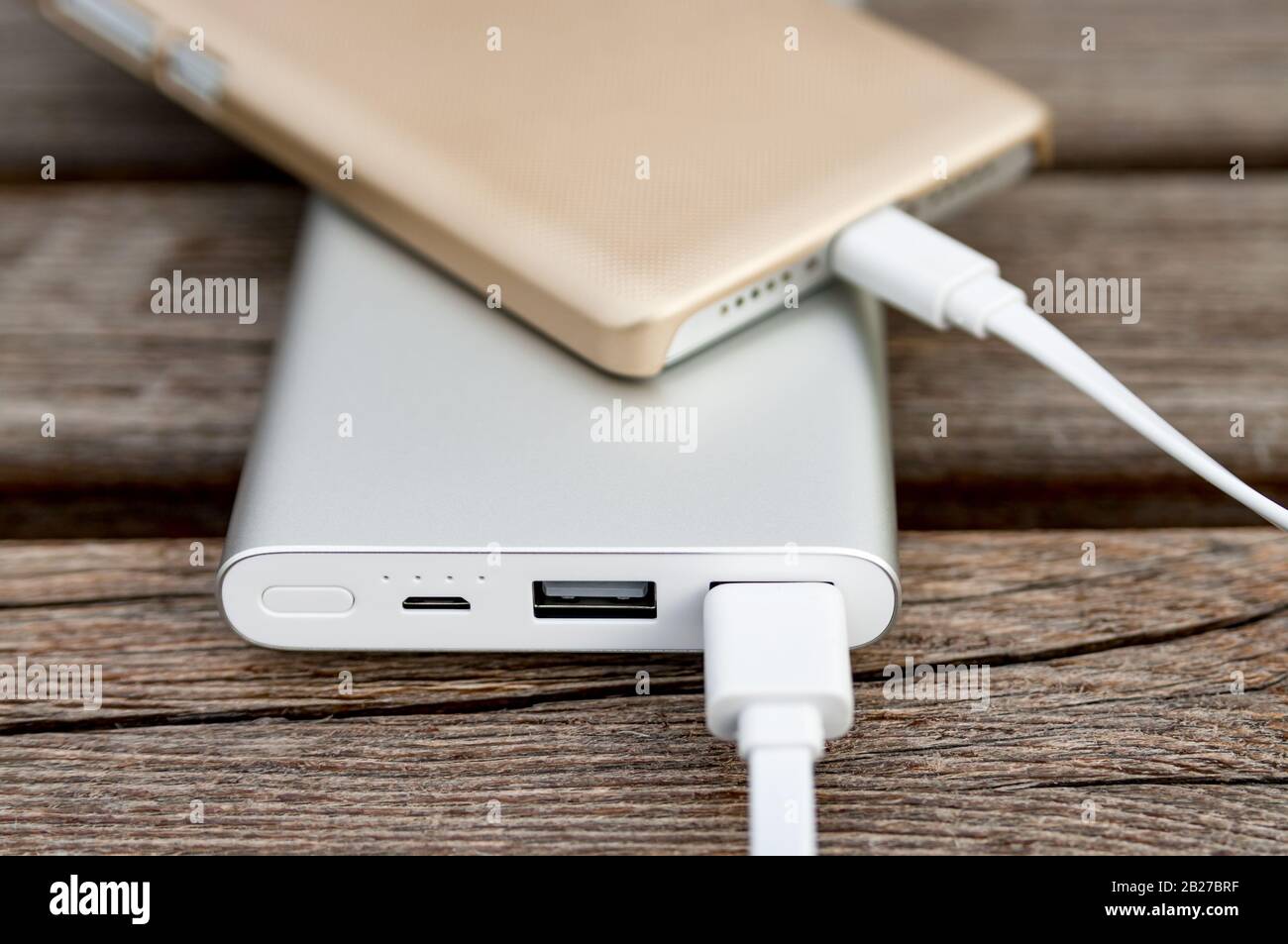 Smartphone charging with powerbank on the bench Stock Photo - Alamy