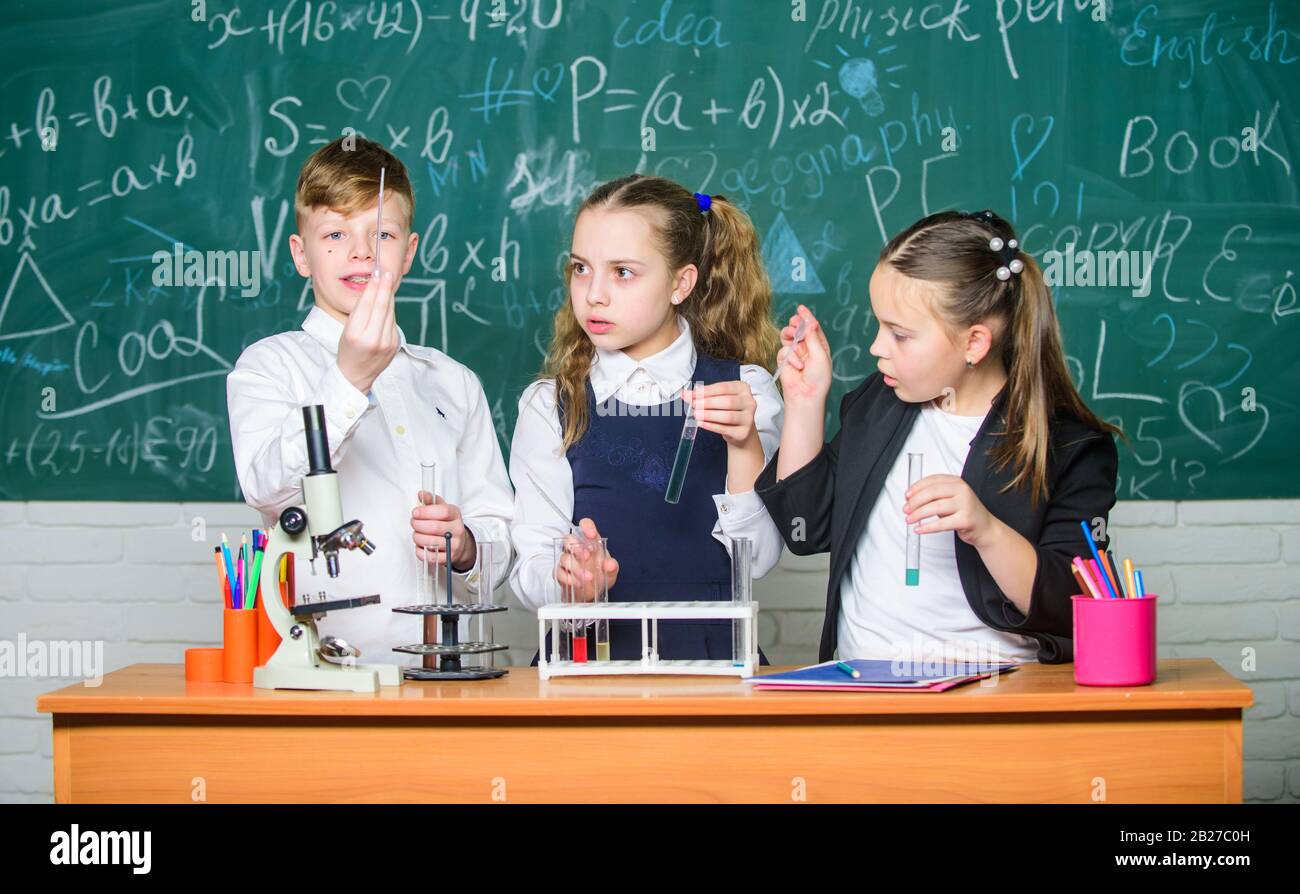 Basic chemical reactions. Group school pupils study chemistry in school ...
