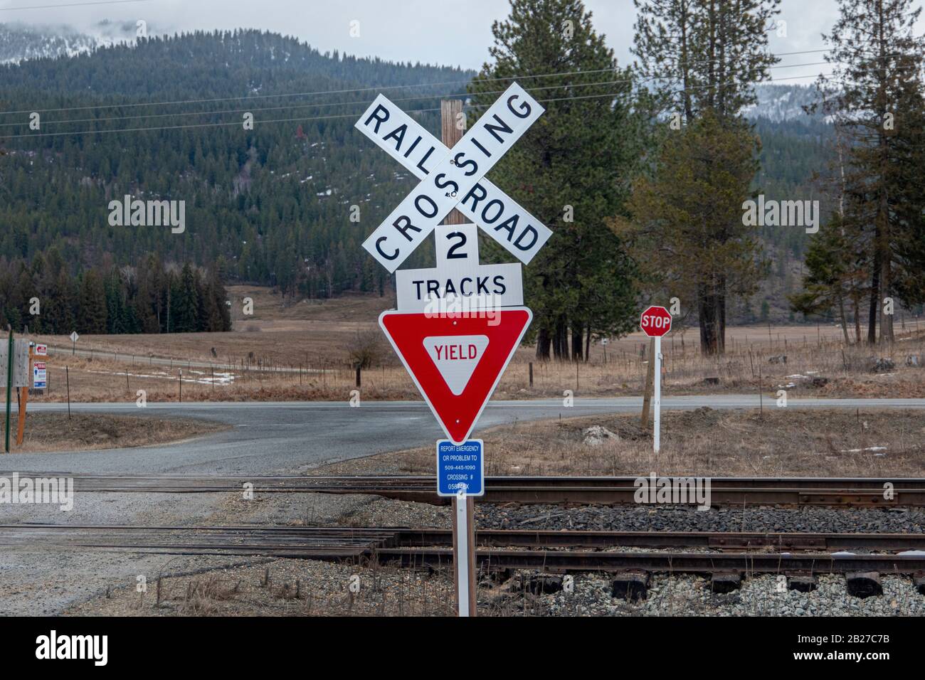 Railroad Crossing sign at a rural junction under the cloudy sky Stock ...