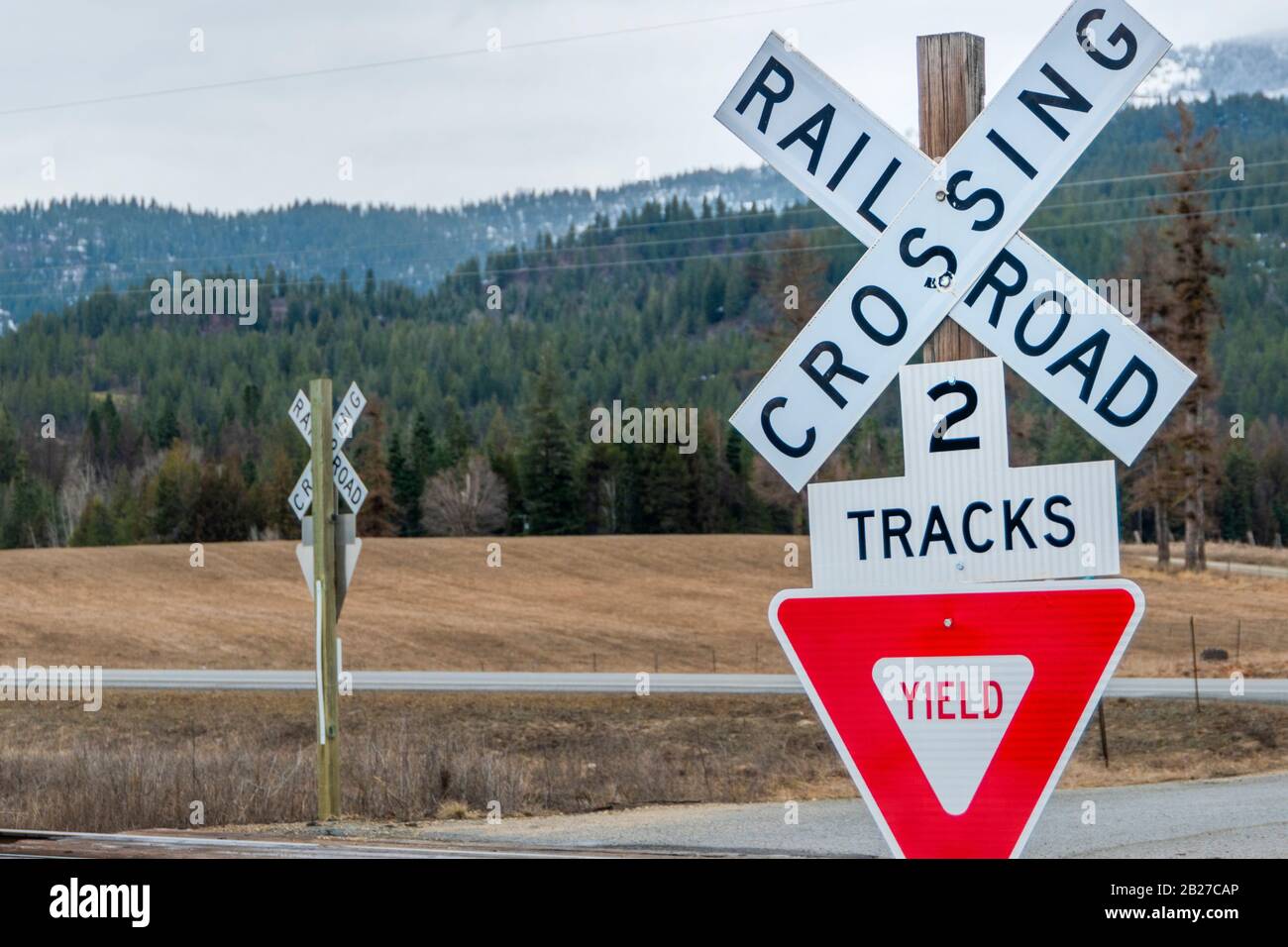 Railroad Crossing sign at a rural junction under the cloudy sky Stock ...