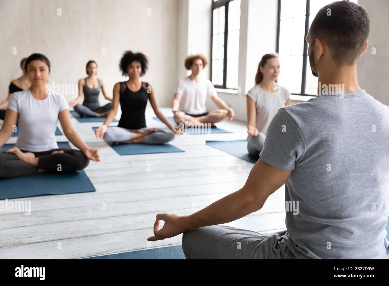 Rear view man meditating sitting hi-res stock photography and images ...