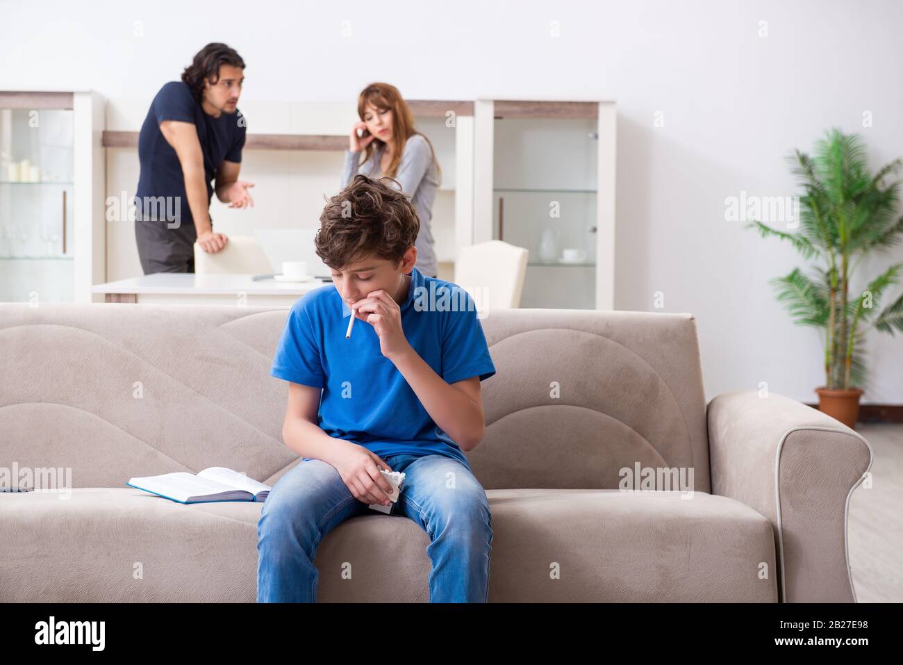 The concept of underage smoking with young boy and family Stock Photo ...
