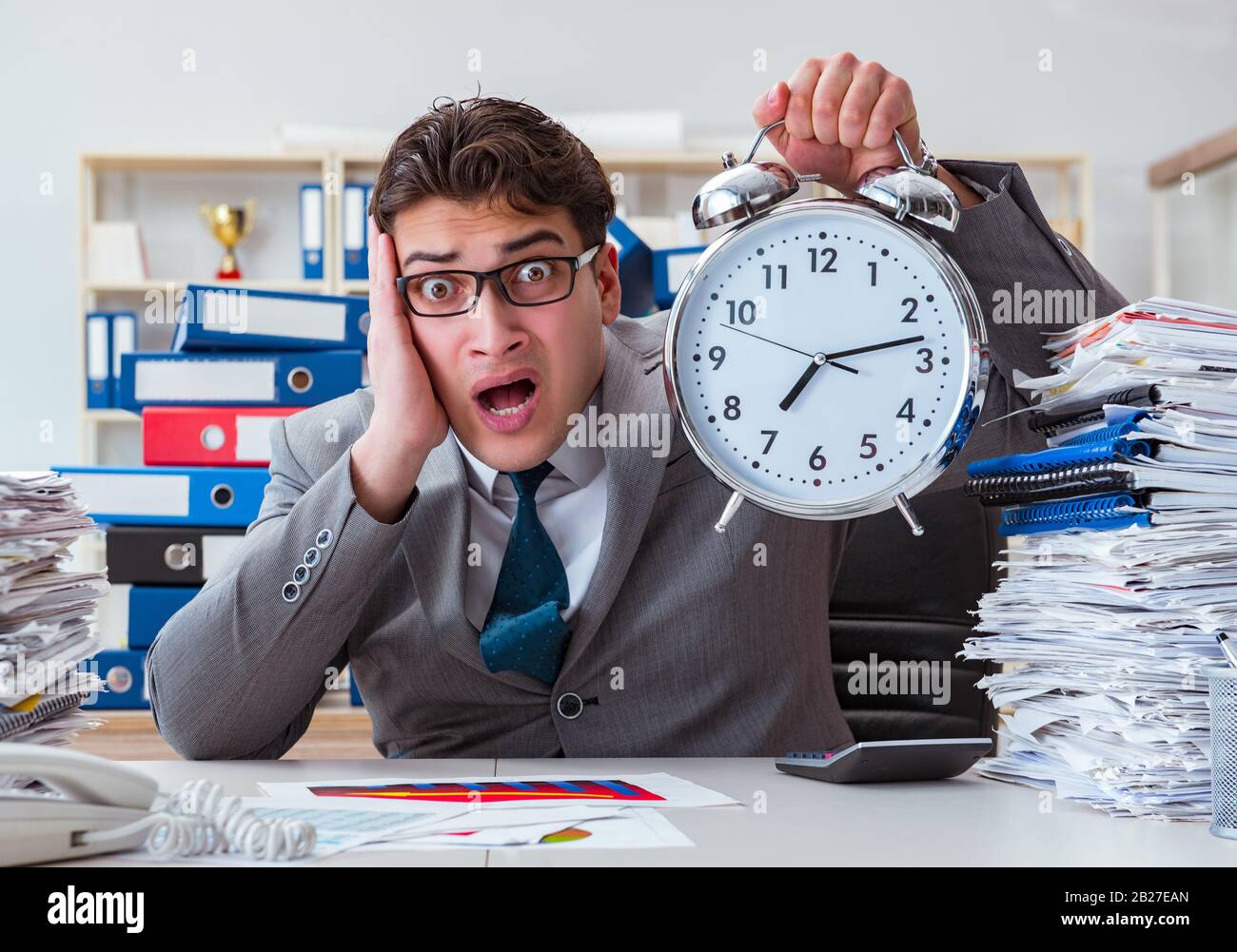 The businessman missing deadlines due to excessive work Stock Photo - Alamy