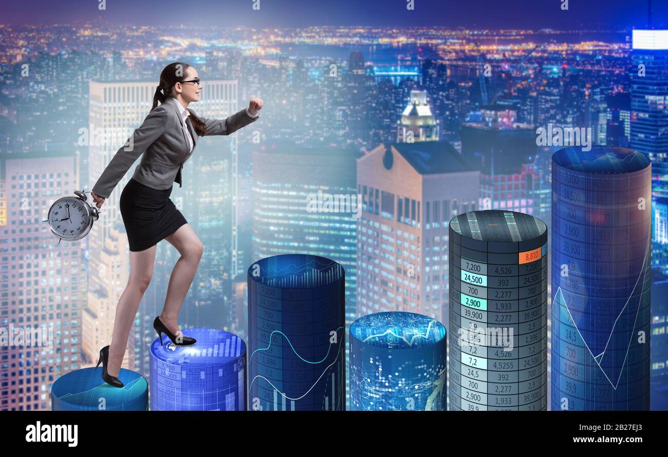 The businesswoman rushing with clock on bar charts Stock Photo - Alamy