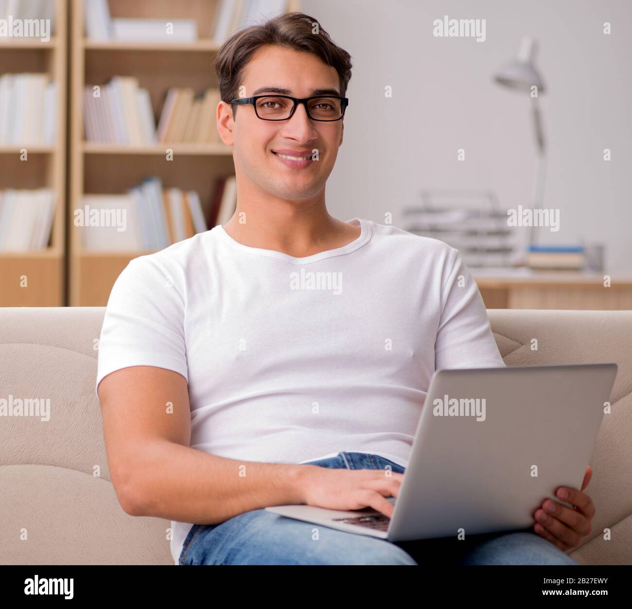 The man working sitting in couch sofa Stock Photo - Alamy