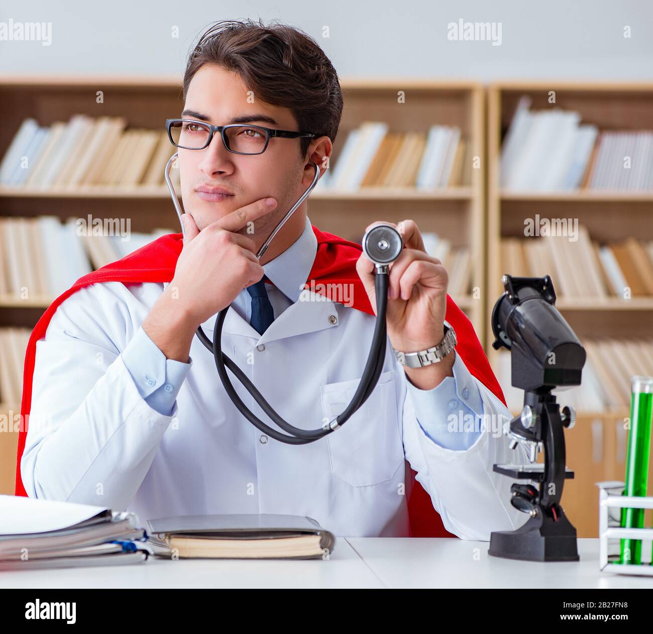 The superhero doctor working in the hospital lab Stock Photo - Alamy