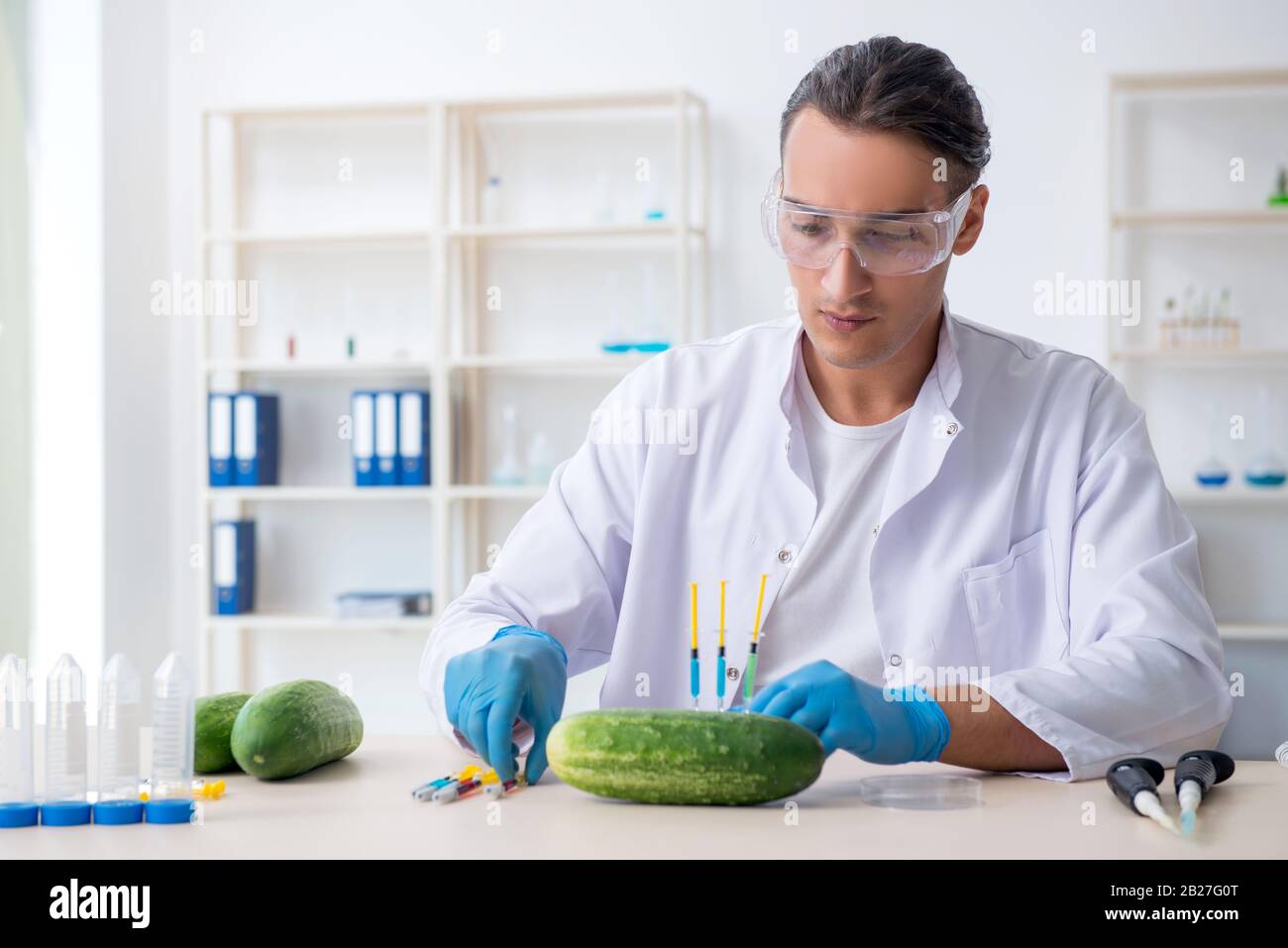 The male nutrition expert testing vegetables in lab Stock Photo - Alamy