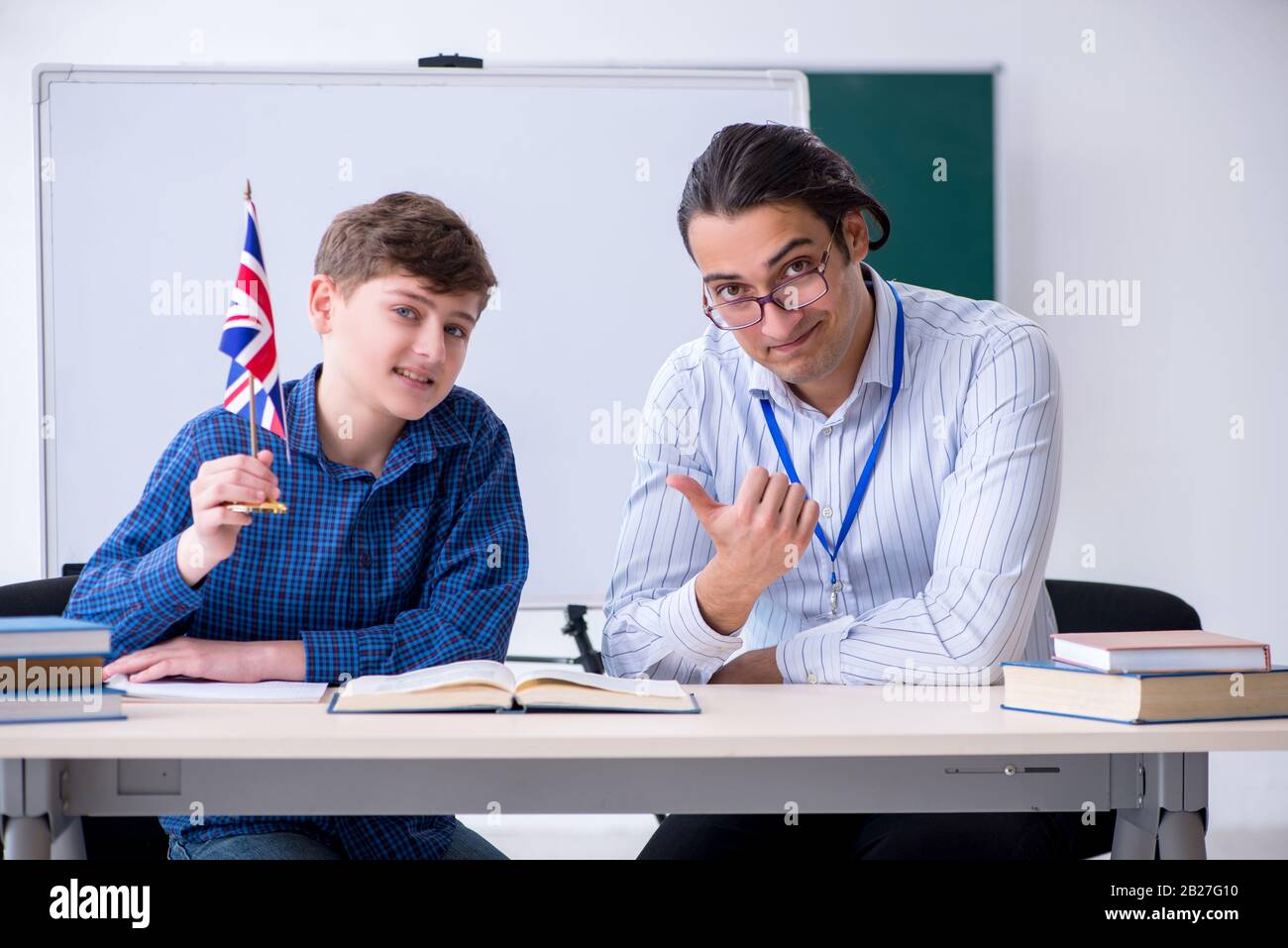The male english teacher and boy in the classroom Stock Photo - Alamy