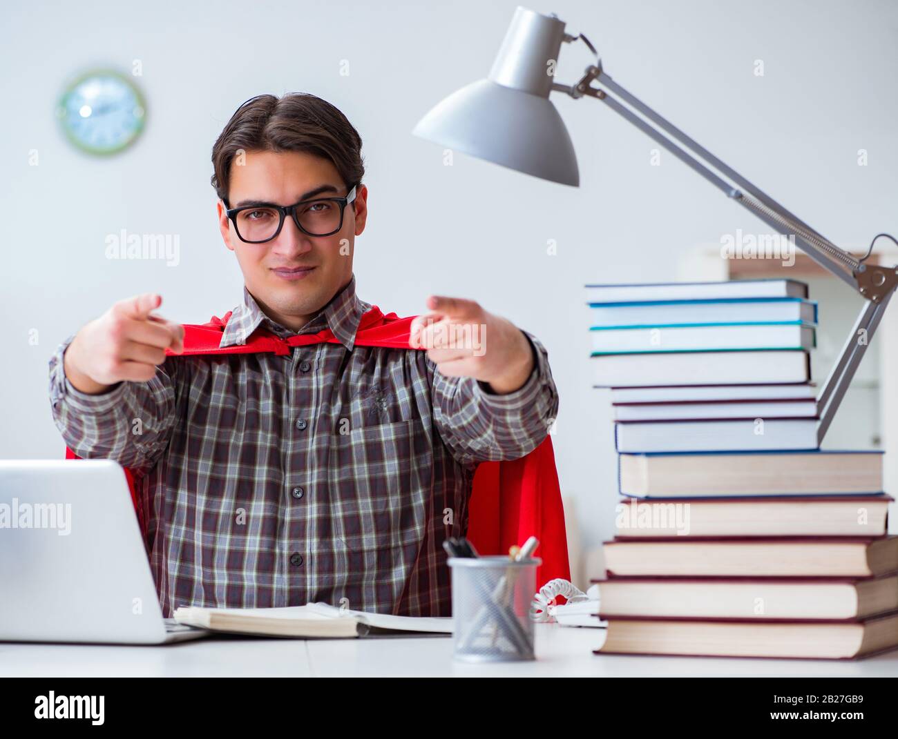 The super hero student with books studying for exams Stock Photo - Alamy