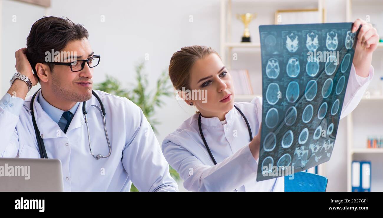 The two doctors examining x-ray images of patient for diagnosis Stock ...