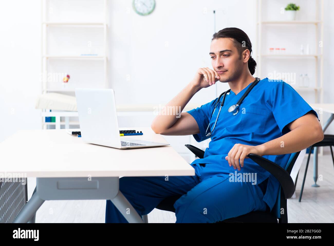 The young male doctor working in the clinic Stock Photo - Alamy