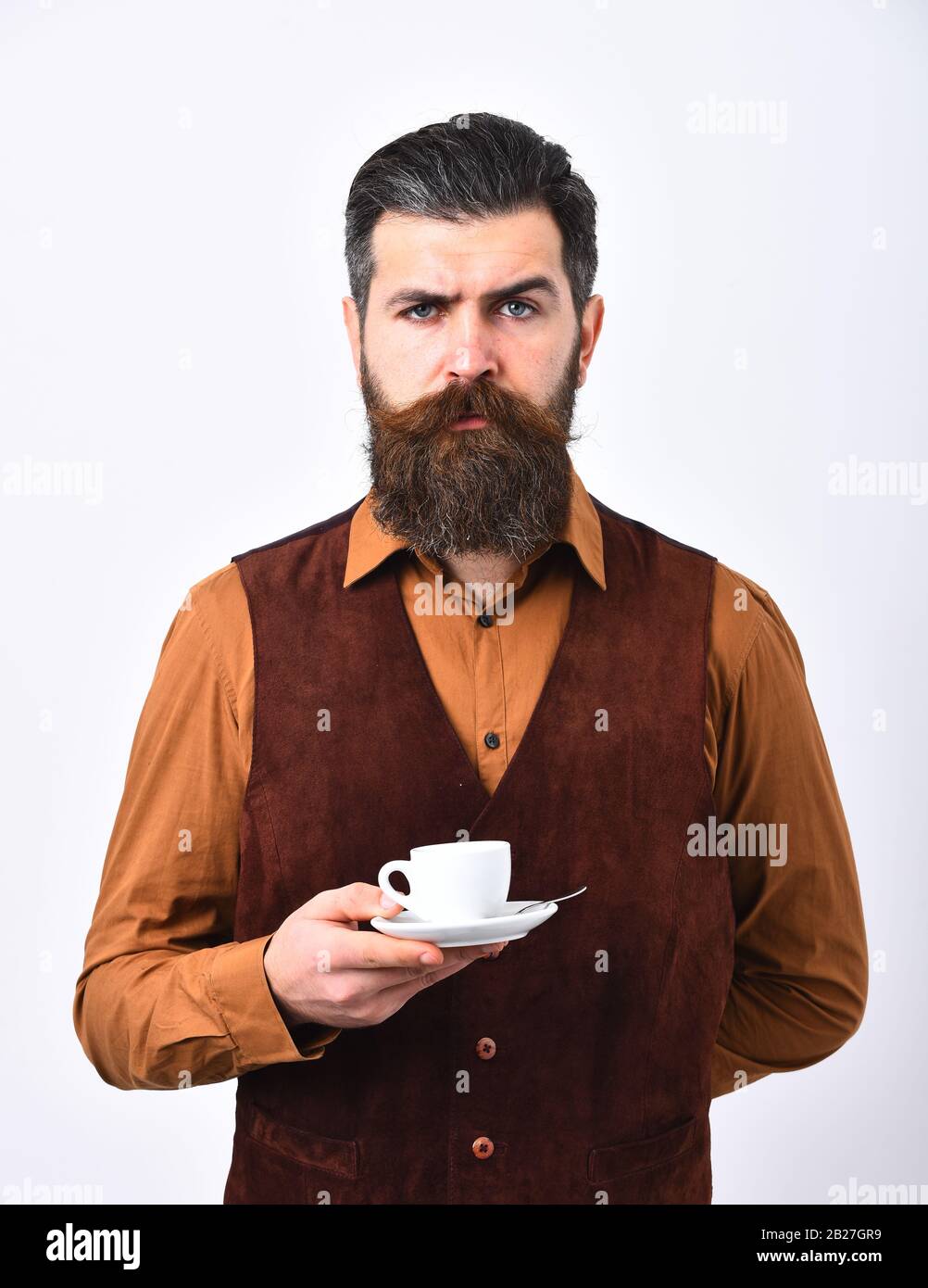 Barman with thoughtful face serves hot coffee. Professional service ...