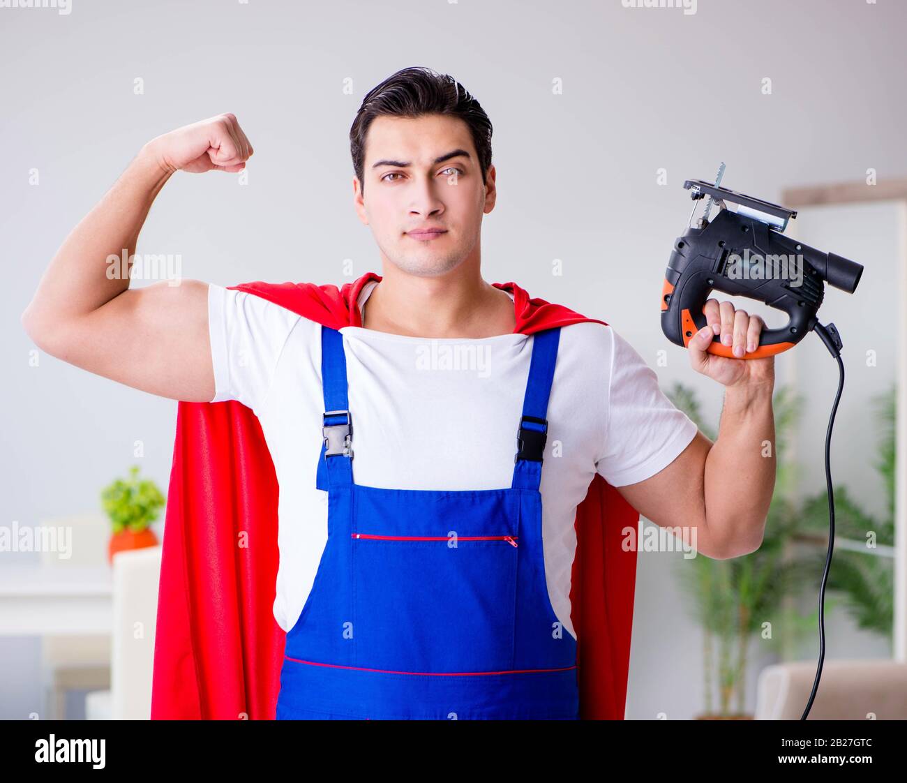 The superhero repairman with tools in repair concept Stock Photo - Alamy