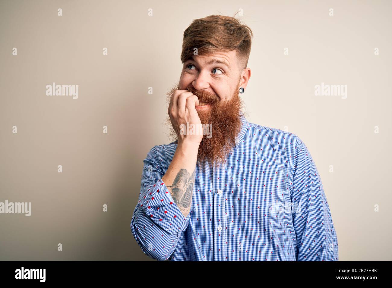 Handsome Irish redhead business man with beard standing over isolated ...