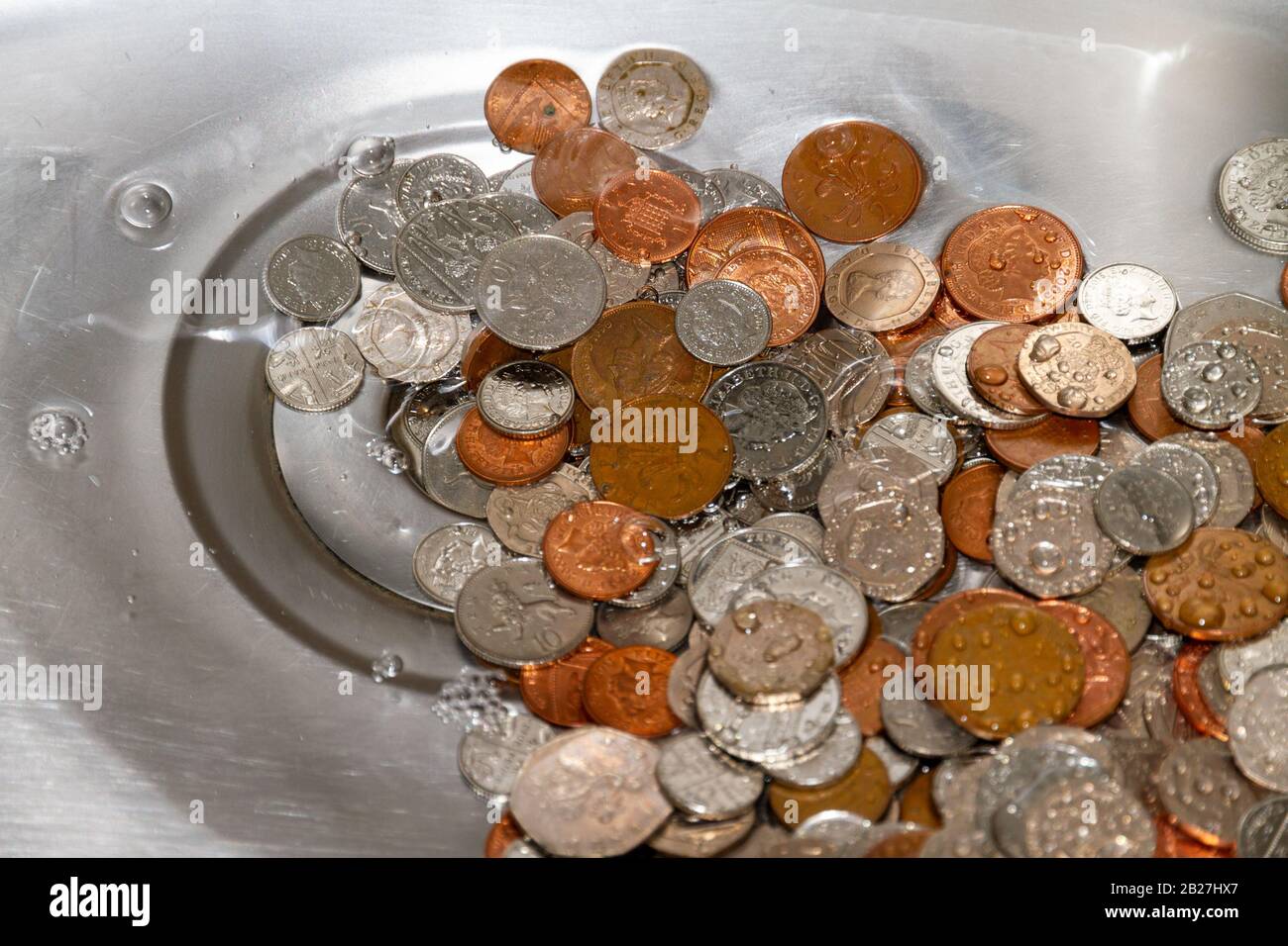 Money down drain hi-res stock photography and images - Alamy