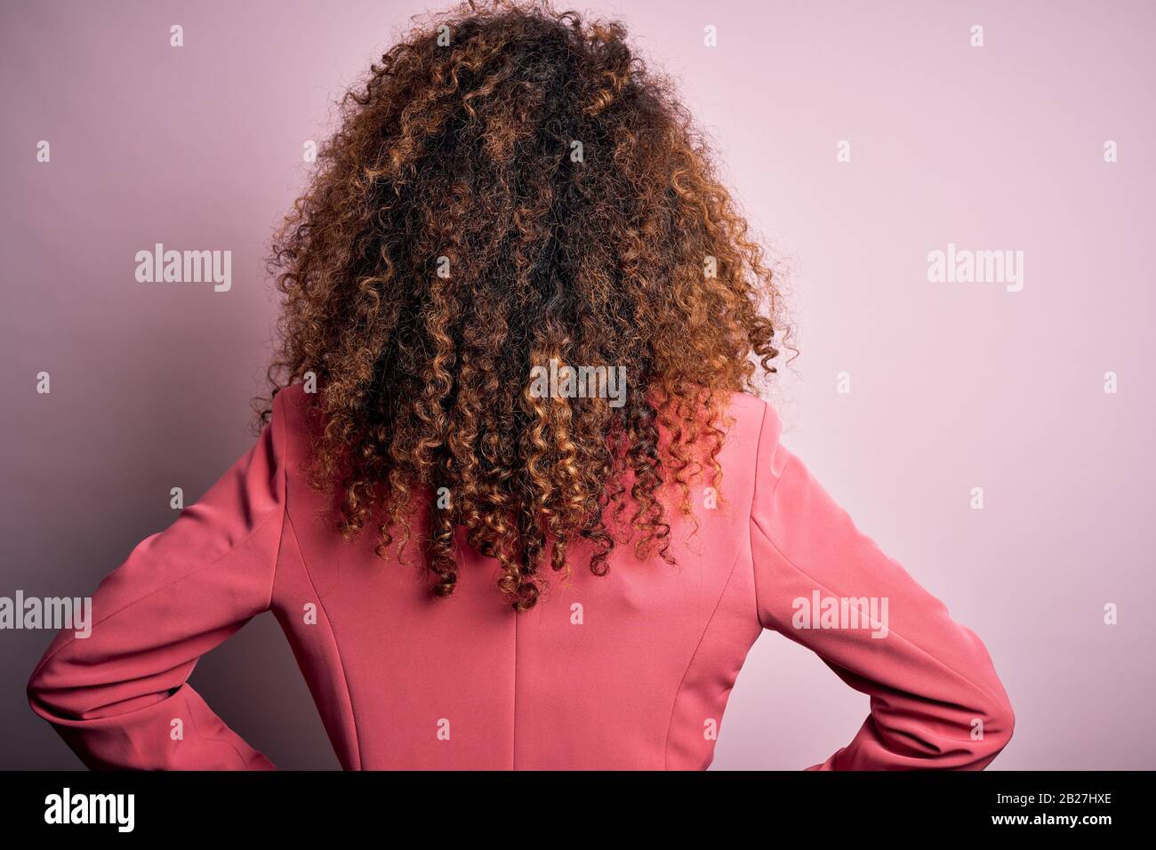 Young beautiful businesswoman with curly hair and piercing wearing ...