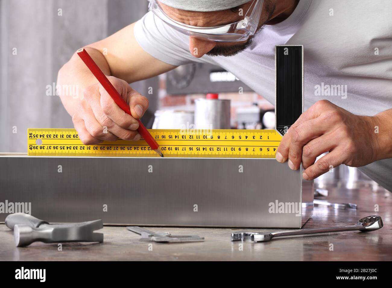 man work in home workshop garage measure metal with ruler angle square ...