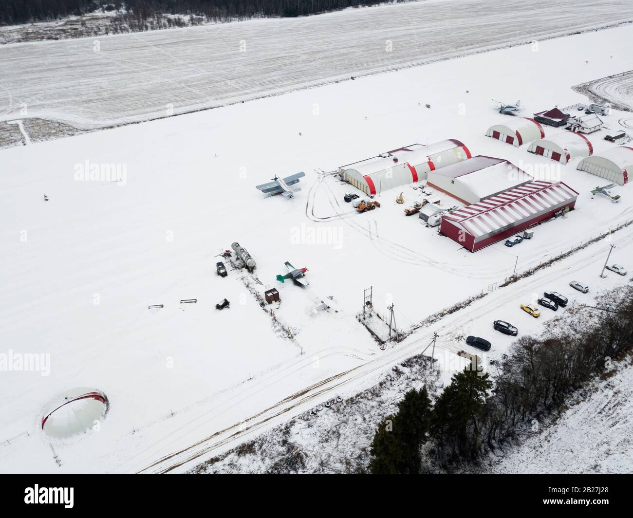 Bird eye view of an airfield with runway and hangars under snow, winter ...