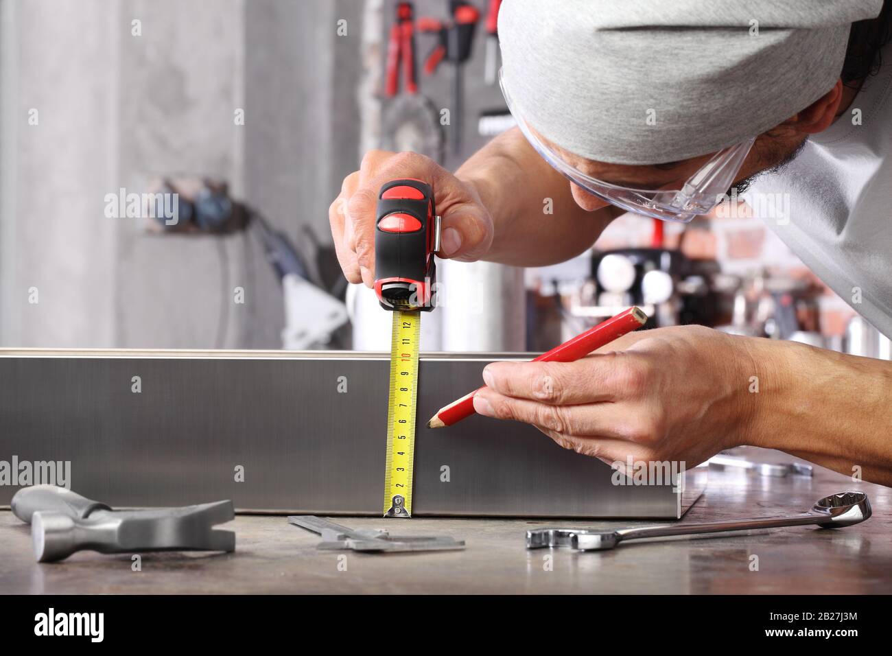 man work in home workshop garage measure metal with tape meter and use ...