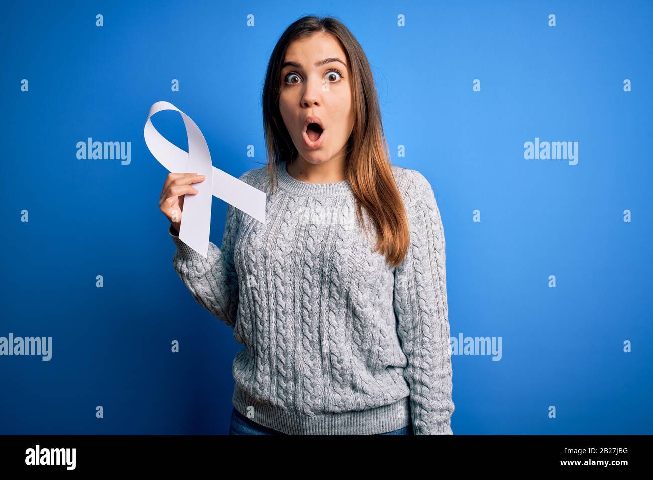 Young blonde woman holding cancer awareness and stop women violence ...