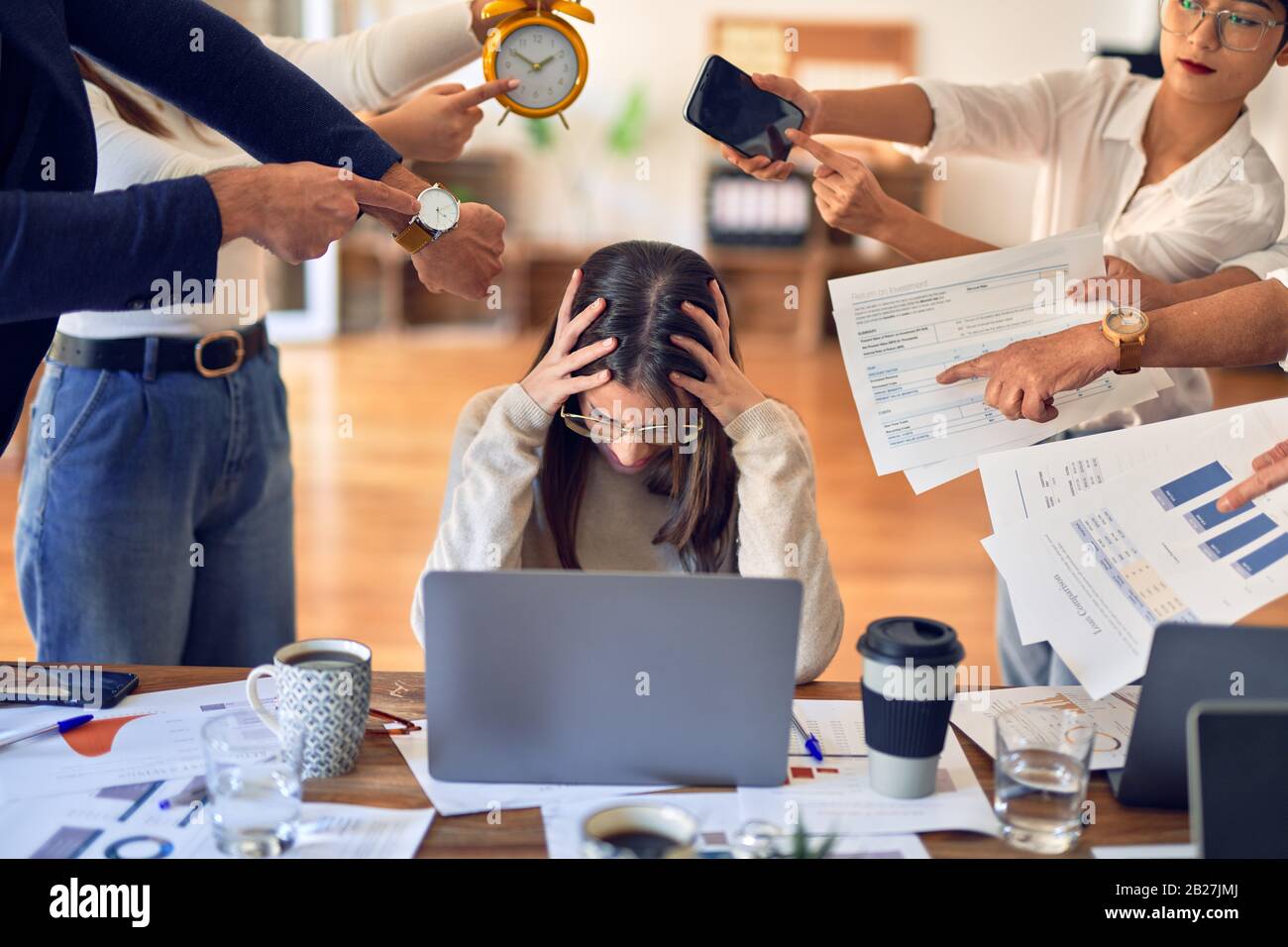 Group of business workers working together. Partners stressing one of ...