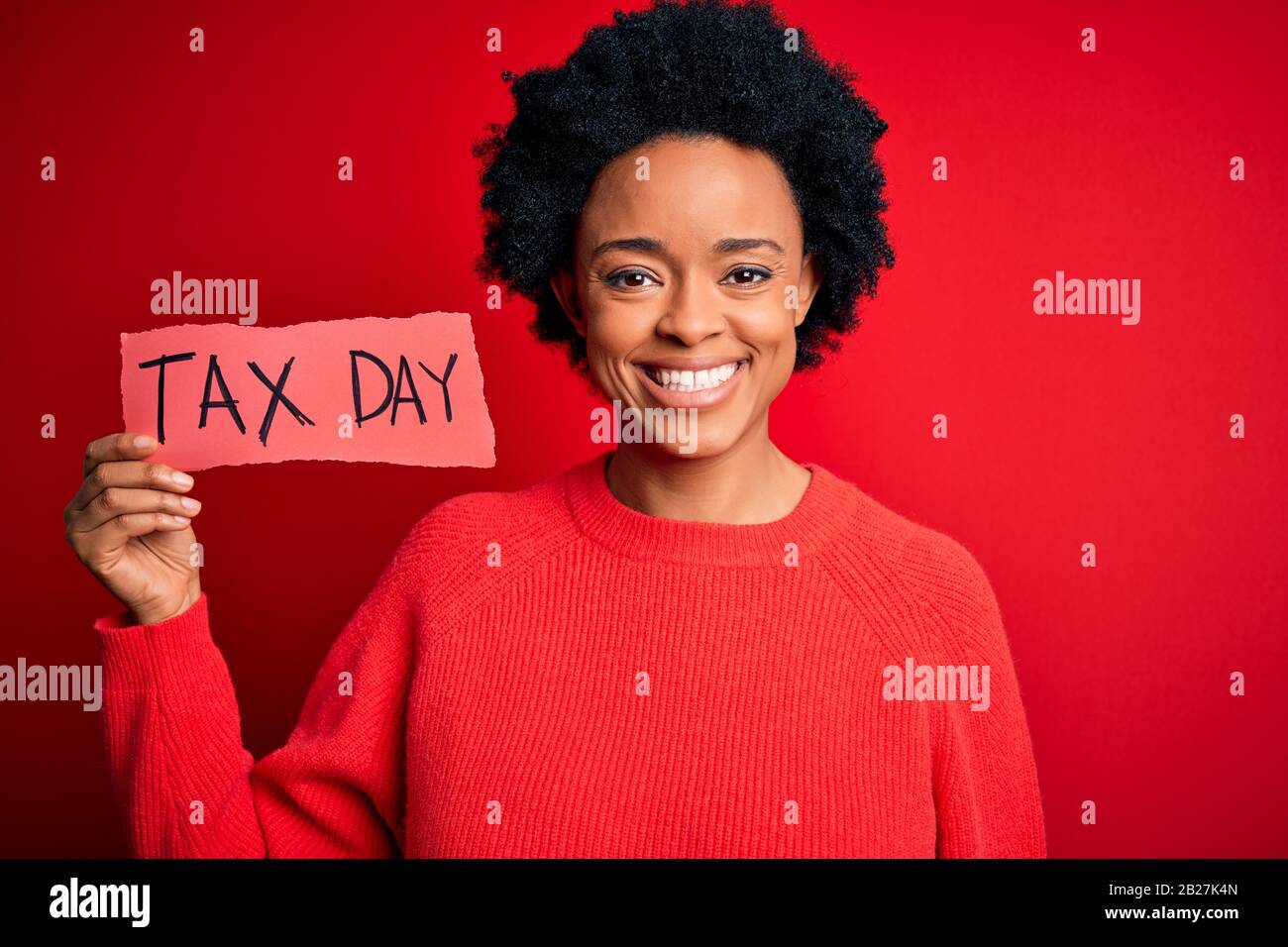 Young African American afro woman with curly hair holding paper with ...