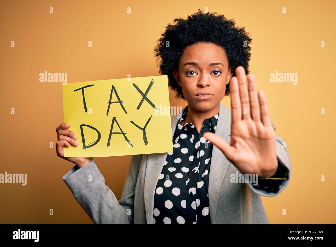 Young African American afro woman with curly hair holding paper with ...