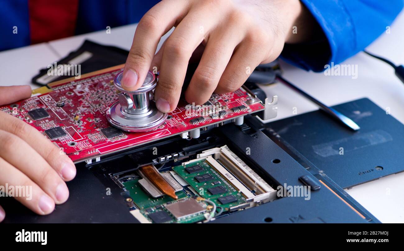 Repairman working in technical support fixing computer laptop ...