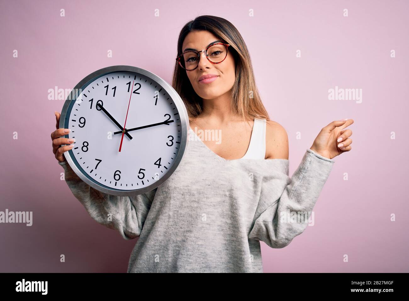 Young beautiful brunette woman wearing glasses doing countdown using ...