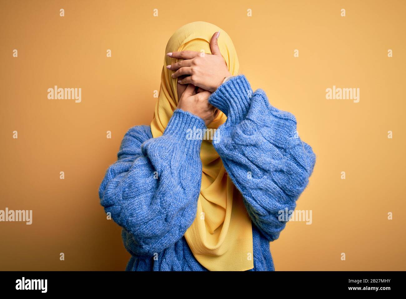 Young beautiful brunette muslim woman wearing arab hijab over isolated ...