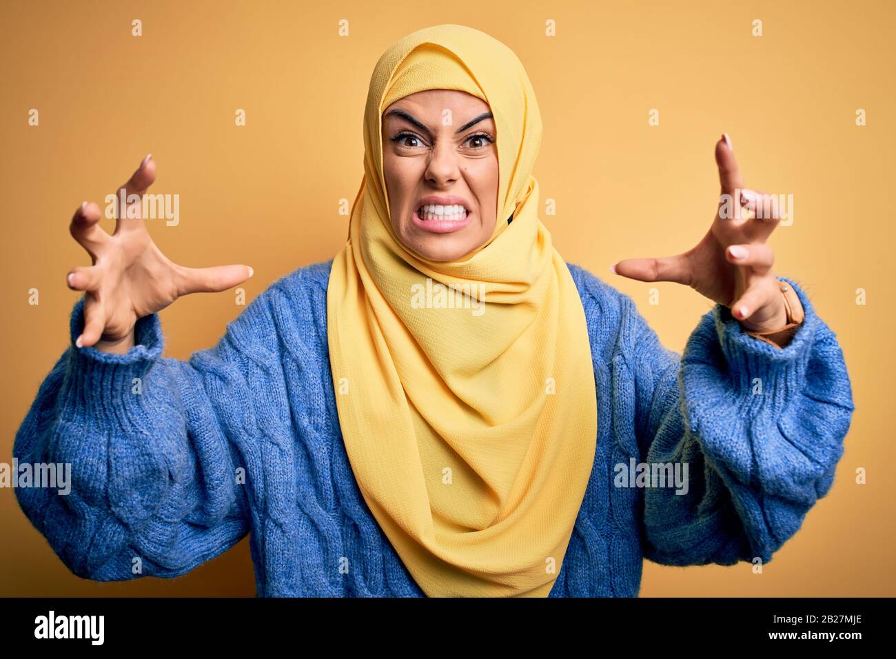Young beautiful brunette muslim woman wearing arab hijab over isolated ...