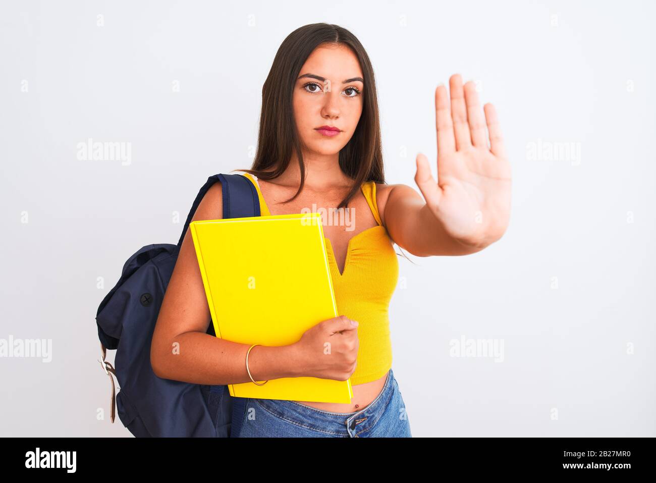Beautiful student girl wearing backpack holding notebook over isolated ...