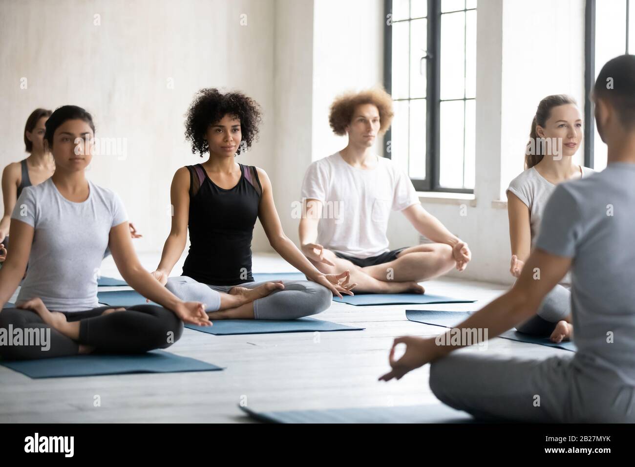 Group of diverse people sitting cross-legged do meditation practice ... Group of diverse people sitting cross-legged do meditation practice ...