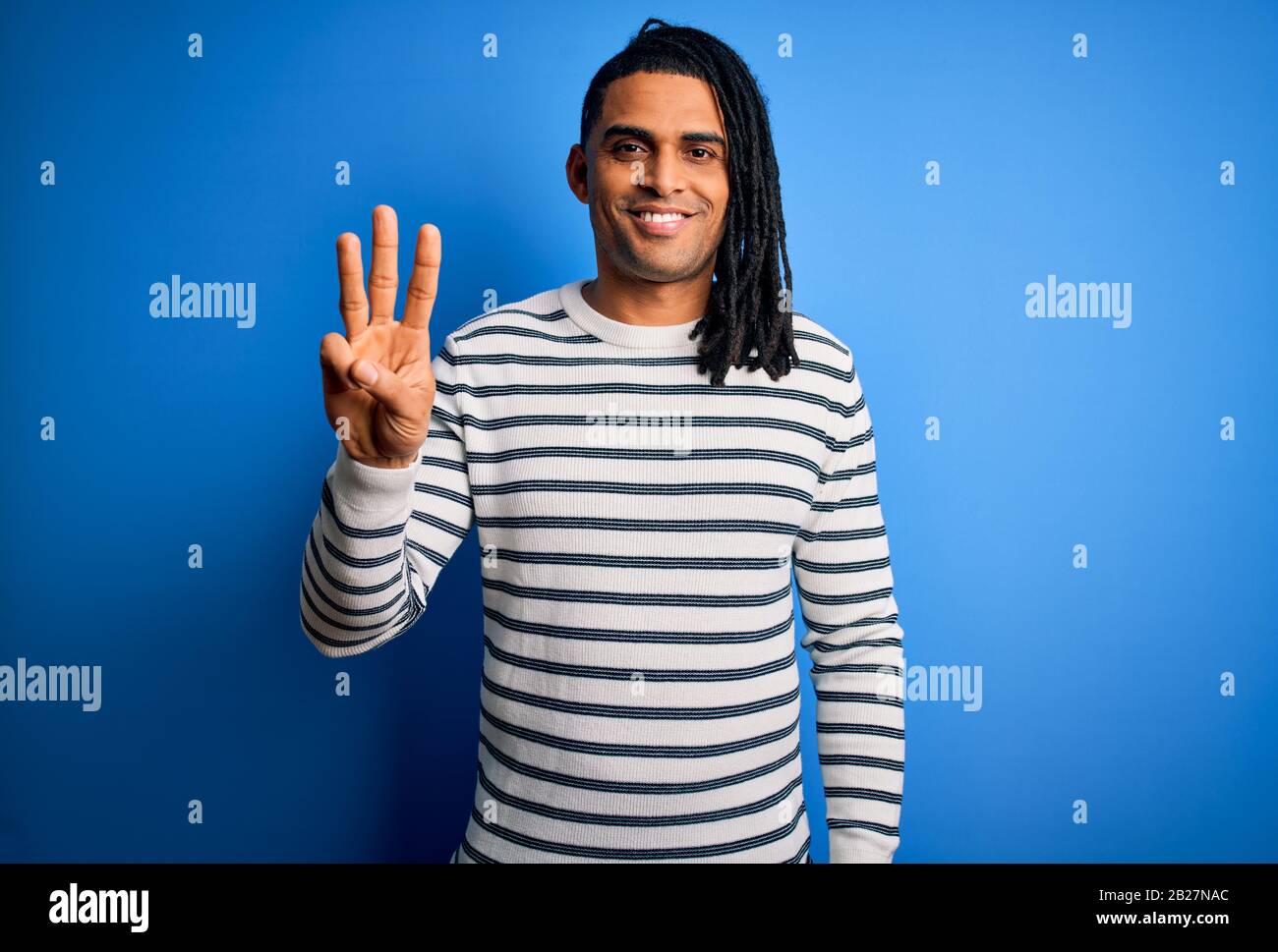 Young handsome african american afro man with dreadlocks wearing casual ...
